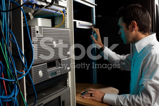 stock-photo-11125557-it-technician-working-at-computer-console-in ...